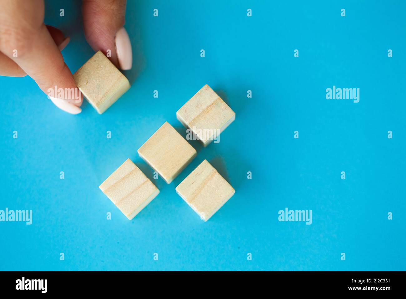 Hand arranging wood block with empty space Stock Photo - Alamy