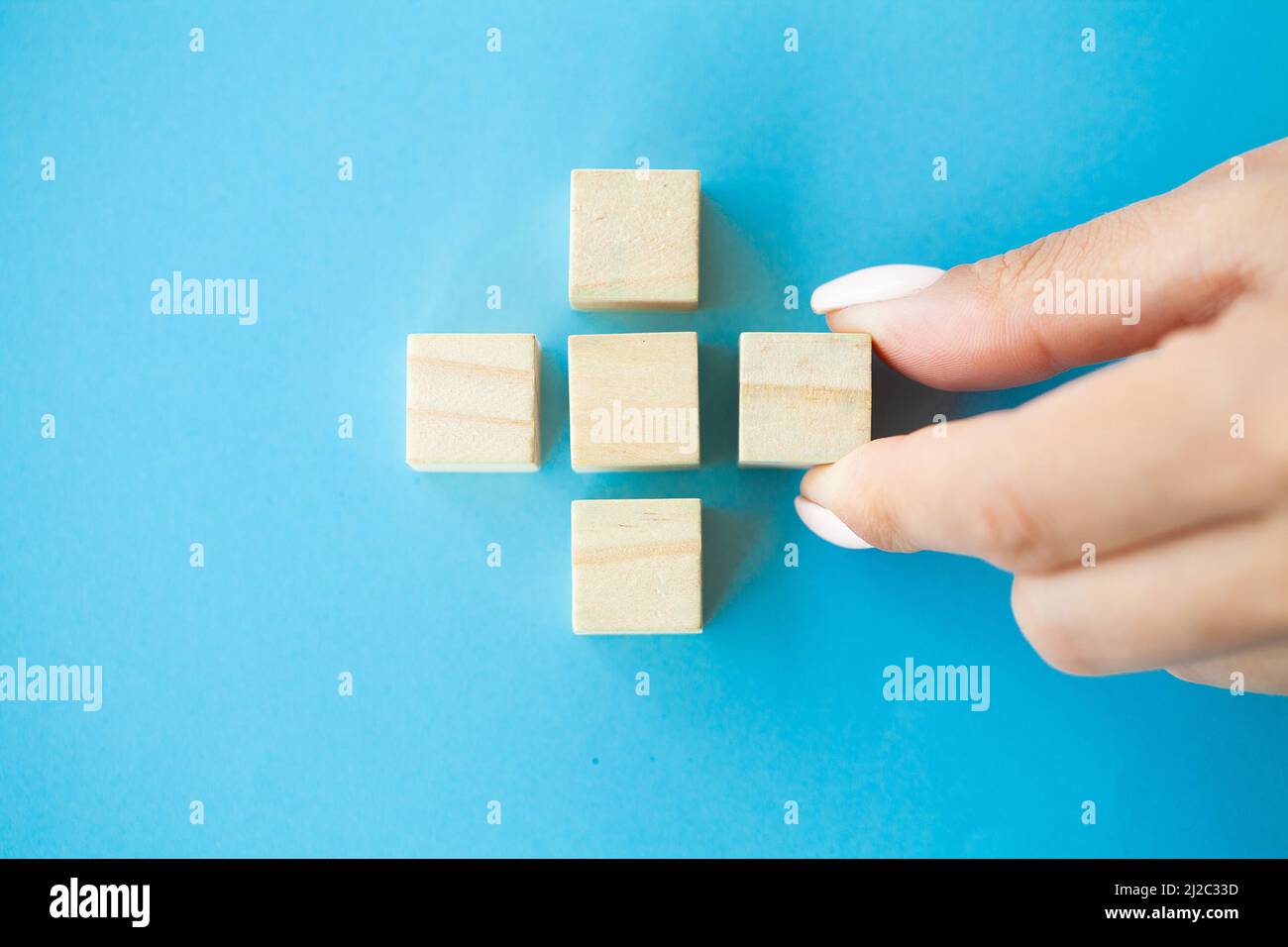 Hand arranging wood block with empty space Stock Photo - Alamy
