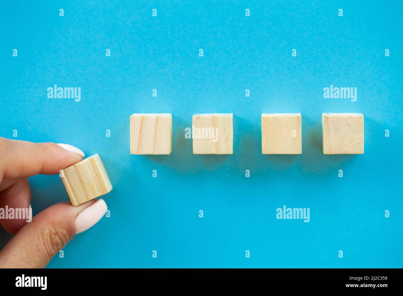 Woman hand arranging wooden cubes hi-res stock photography and images ...