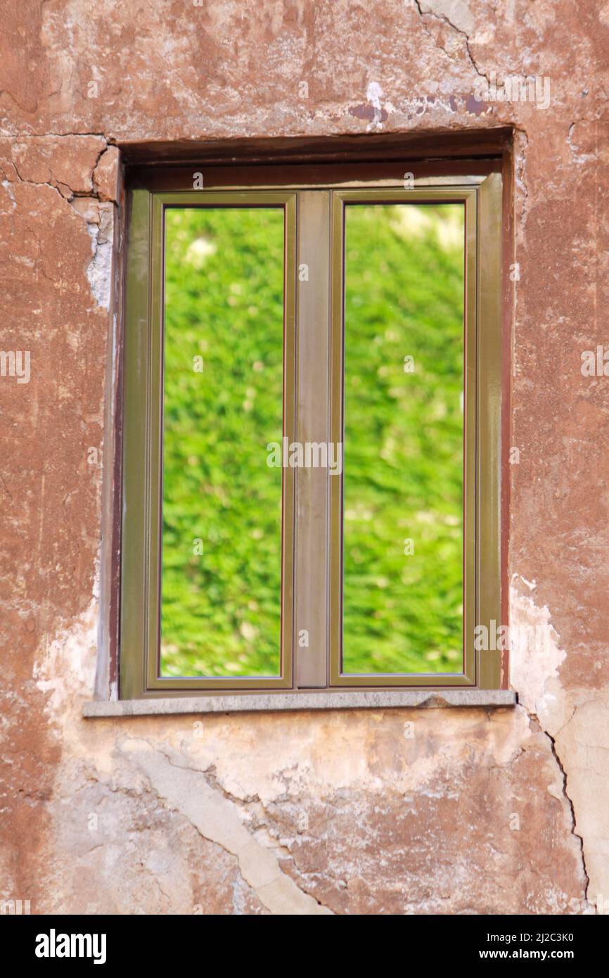 Single window closeup in a cracked wall Stock Photo - Alamy