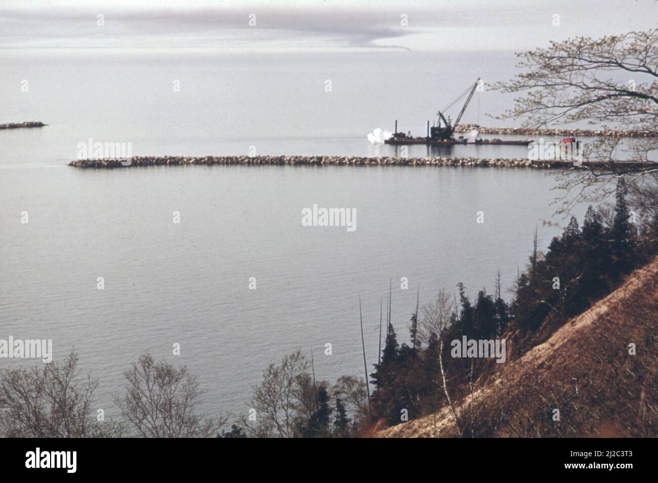 Dredge barge at work inside breakwater of Consumer Power Plant at ...