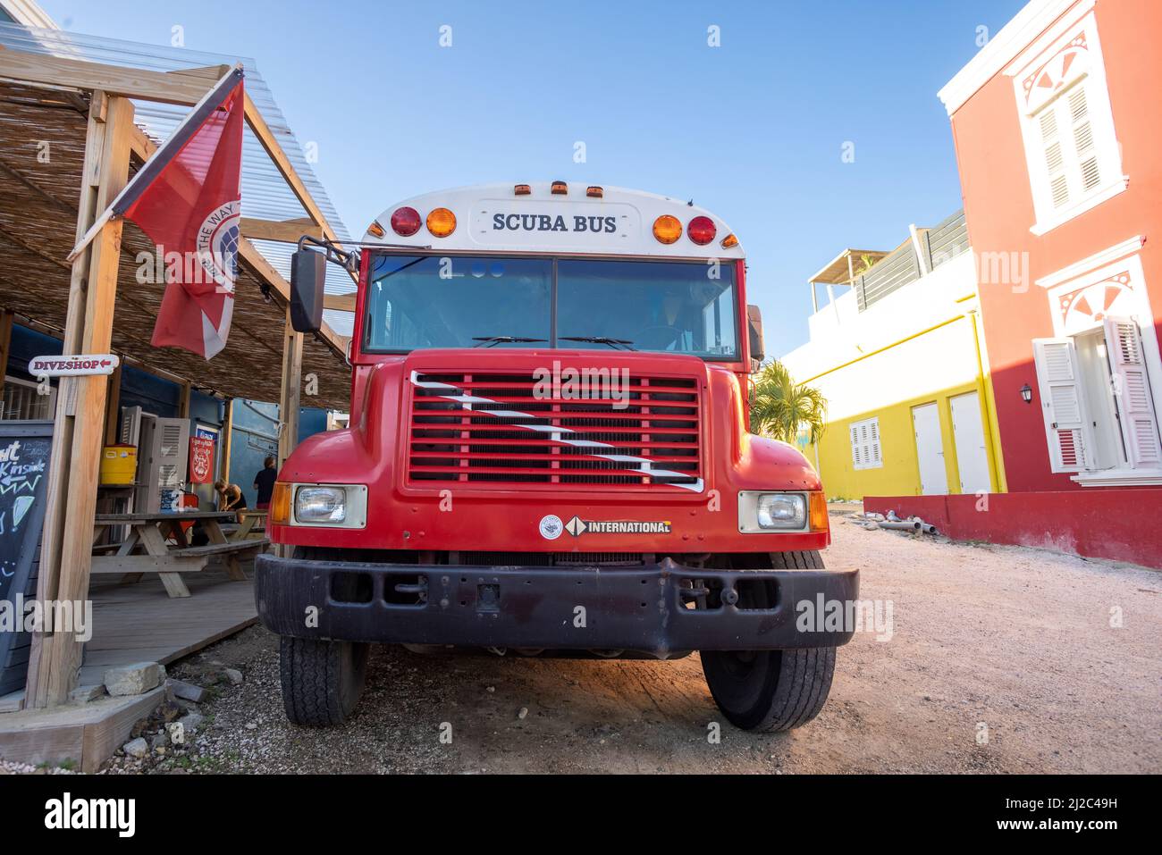 Red bus with a white roof and white stripe in Willemstad, Curacao Stock ...