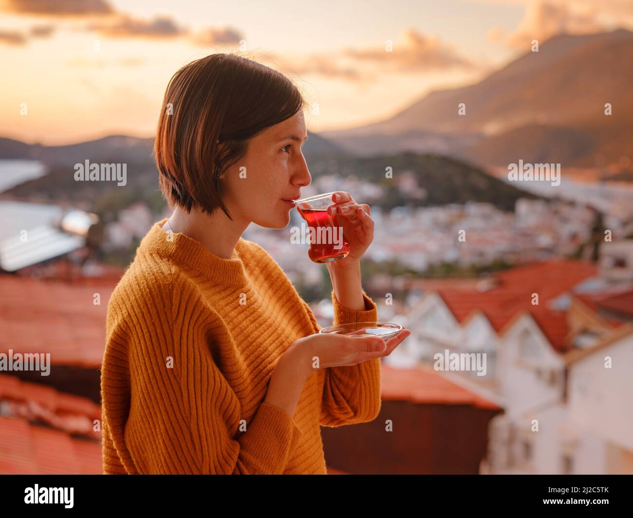 Woman drinking turkish tea from traditional turkish teacup and enjoys ...