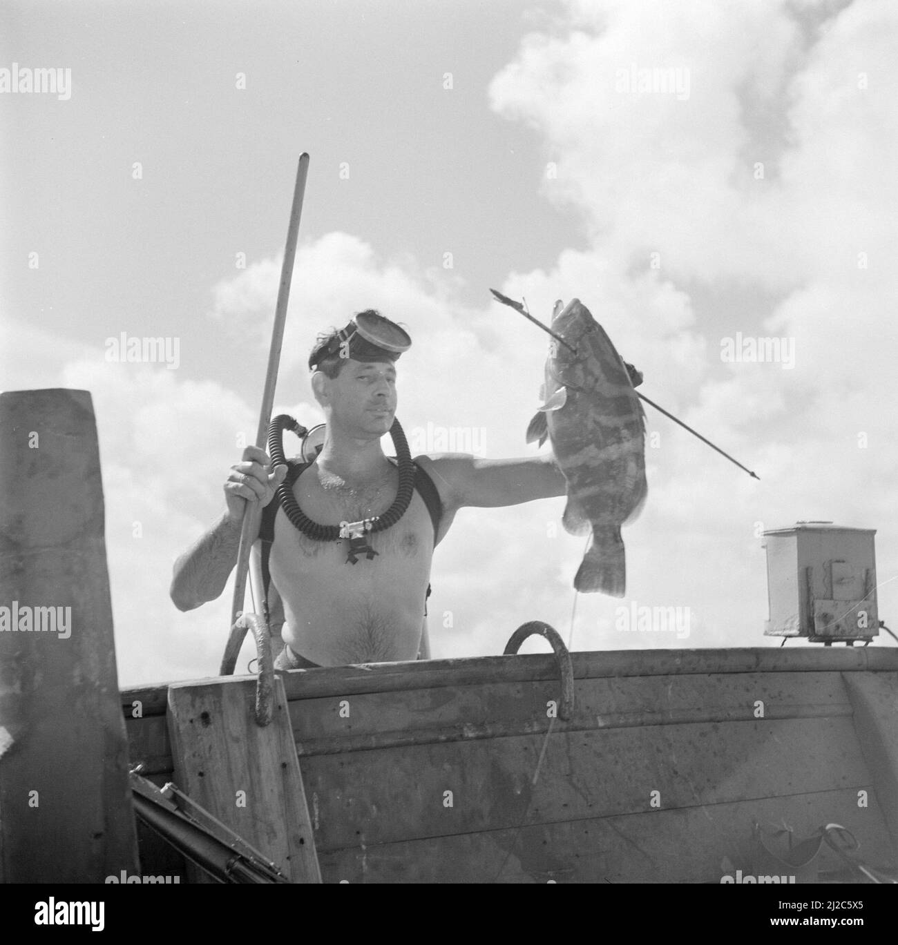A diver with a fish caught on board a ship in the Fuikbaai ca. October ...