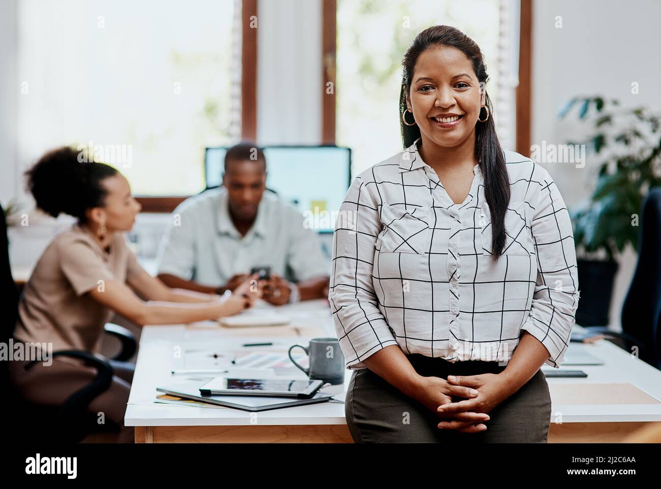 What an awesome team working behind me. Portrait of a confident young ...