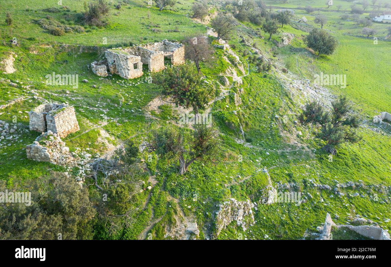 Traditional stone building ruins on slope of a hill. Rural depopulation ...