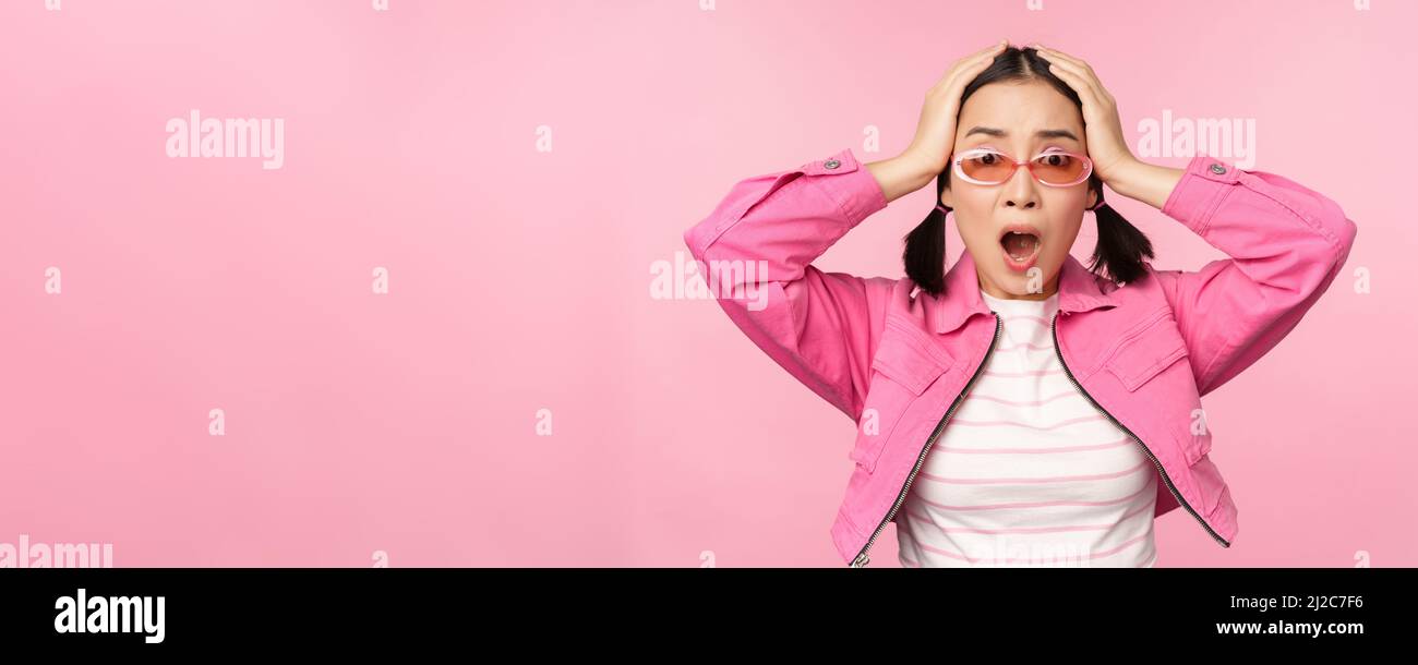 Portrait of troubled asian woman, korean girl holds hands on head and ...