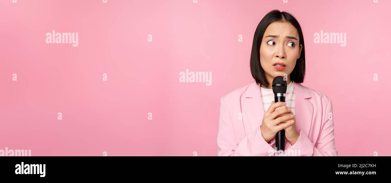 Insecure asian businesswoman giving speech, scared of talking in public ...