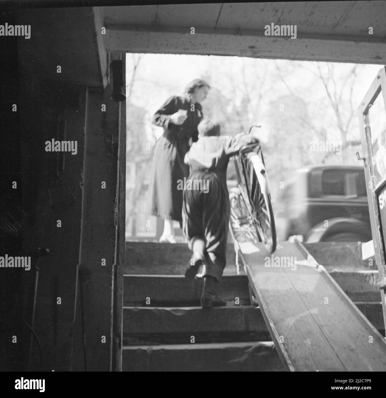 Boy taking his bicycle from basement hi-res stock photography and ...