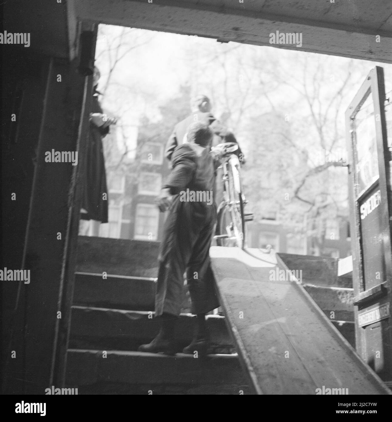 Boy taking his bicycle from basement hi-res stock photography and ...