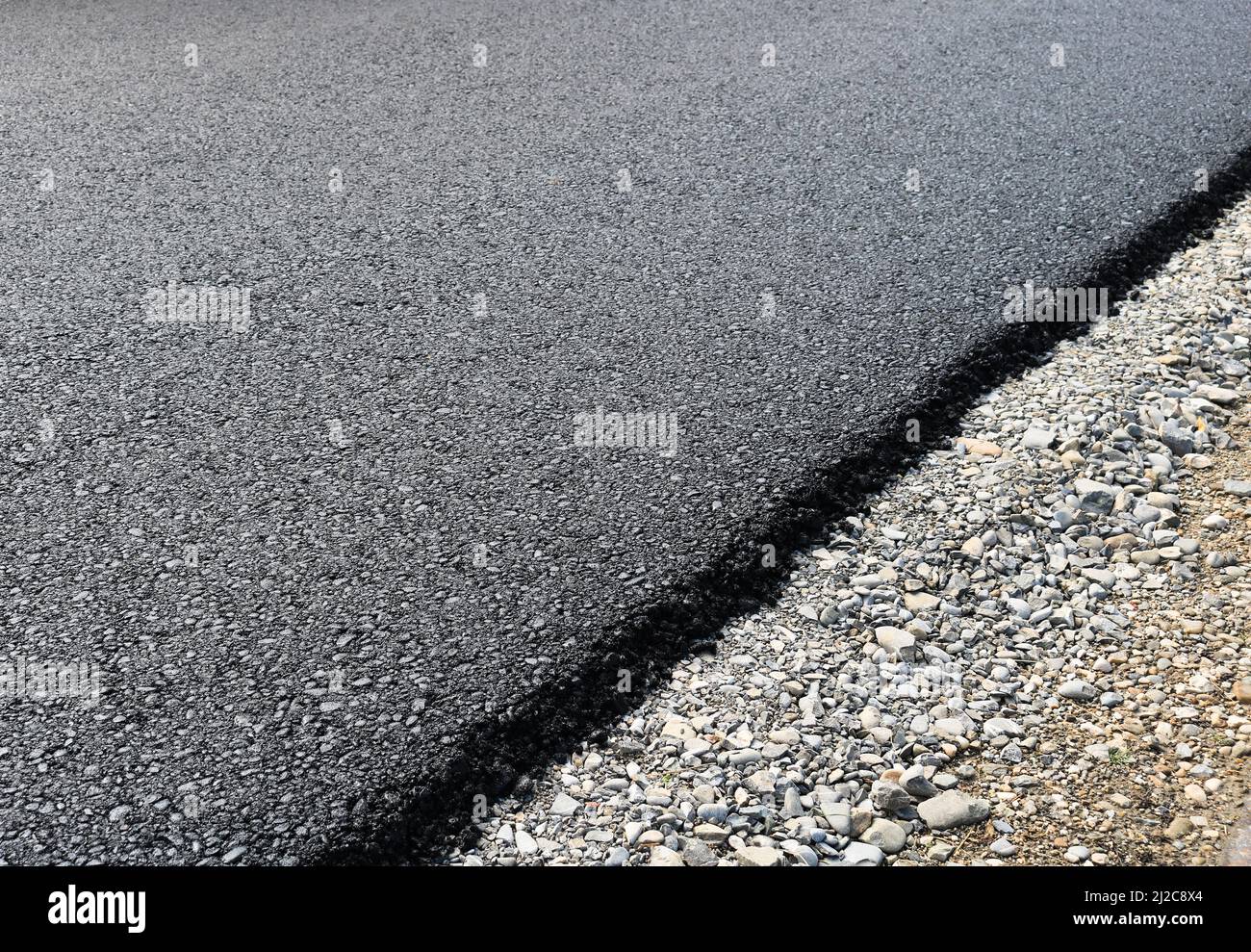 New layer of asphalt road under construction Stock Photo - Alamy