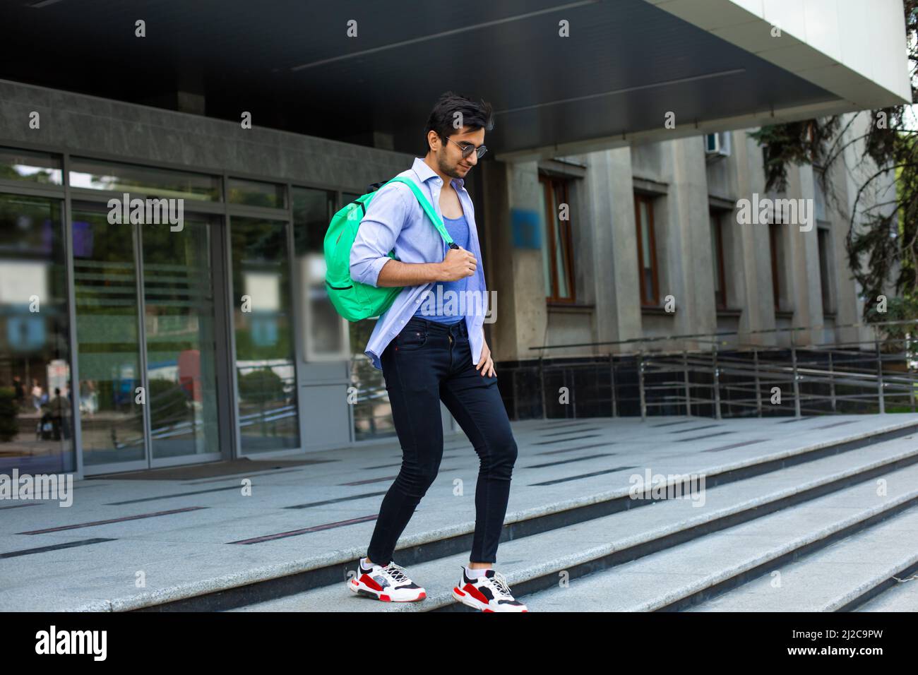The confident student leaves the university building Stock Photo - Alamy