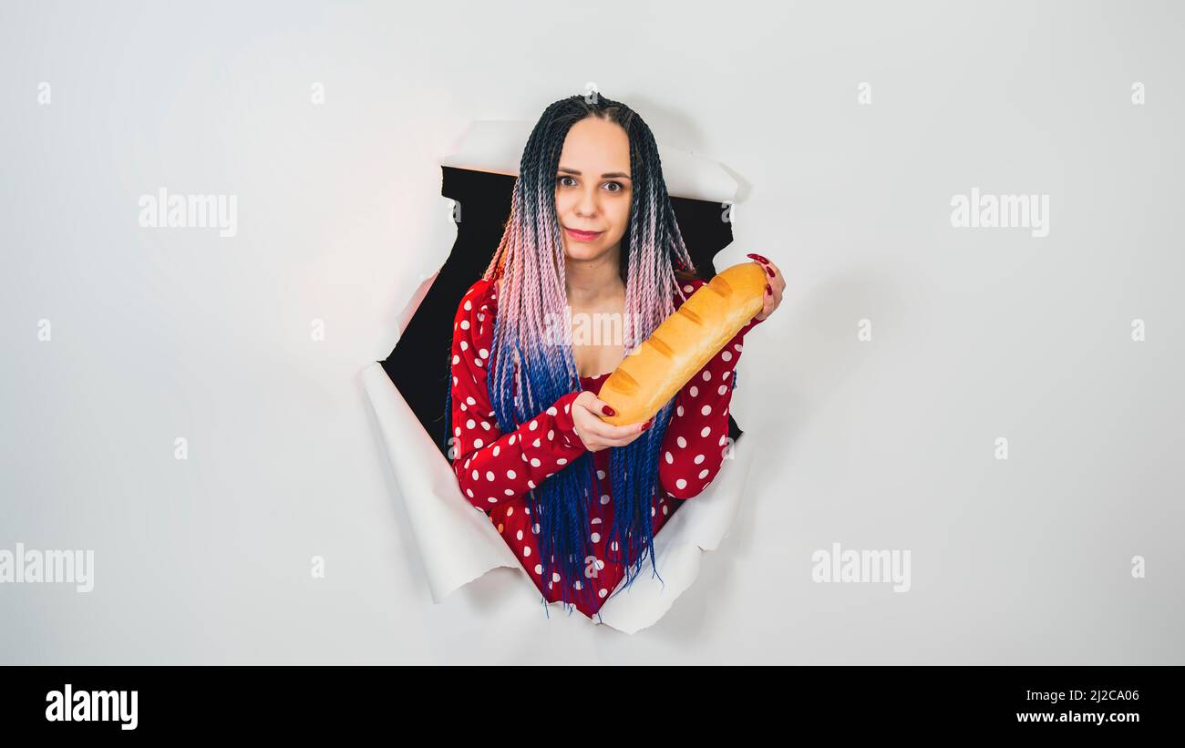 Female in a red dress with loaf in hole of white background Stock Photo ...