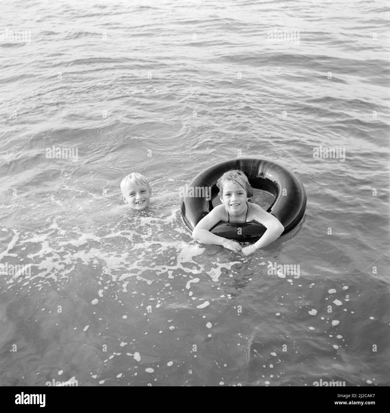 Children swimming in a lake ca. October 1955 Stock Photo - Alamy