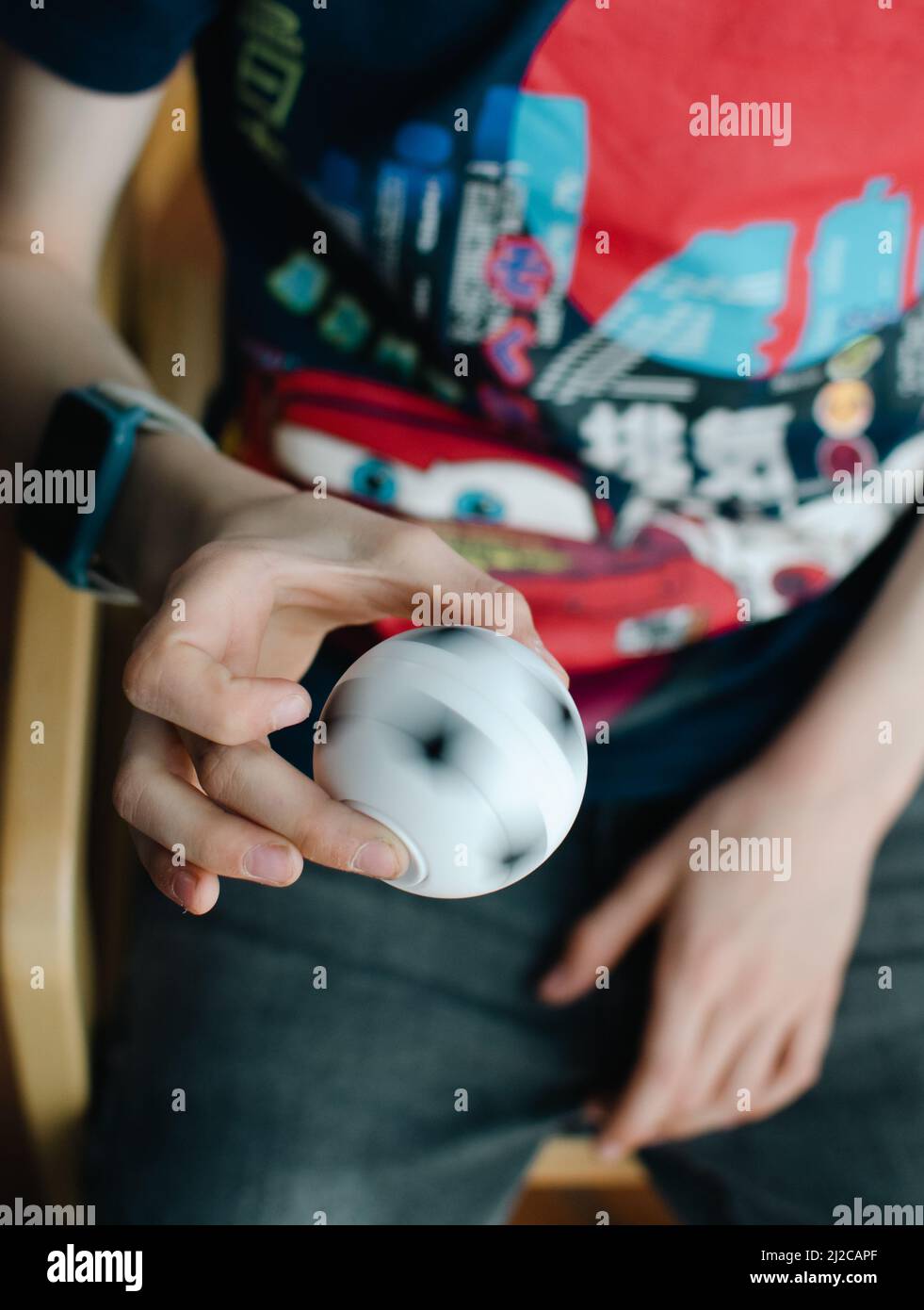 Boy using fidget spinner Stock Photo - Alamy