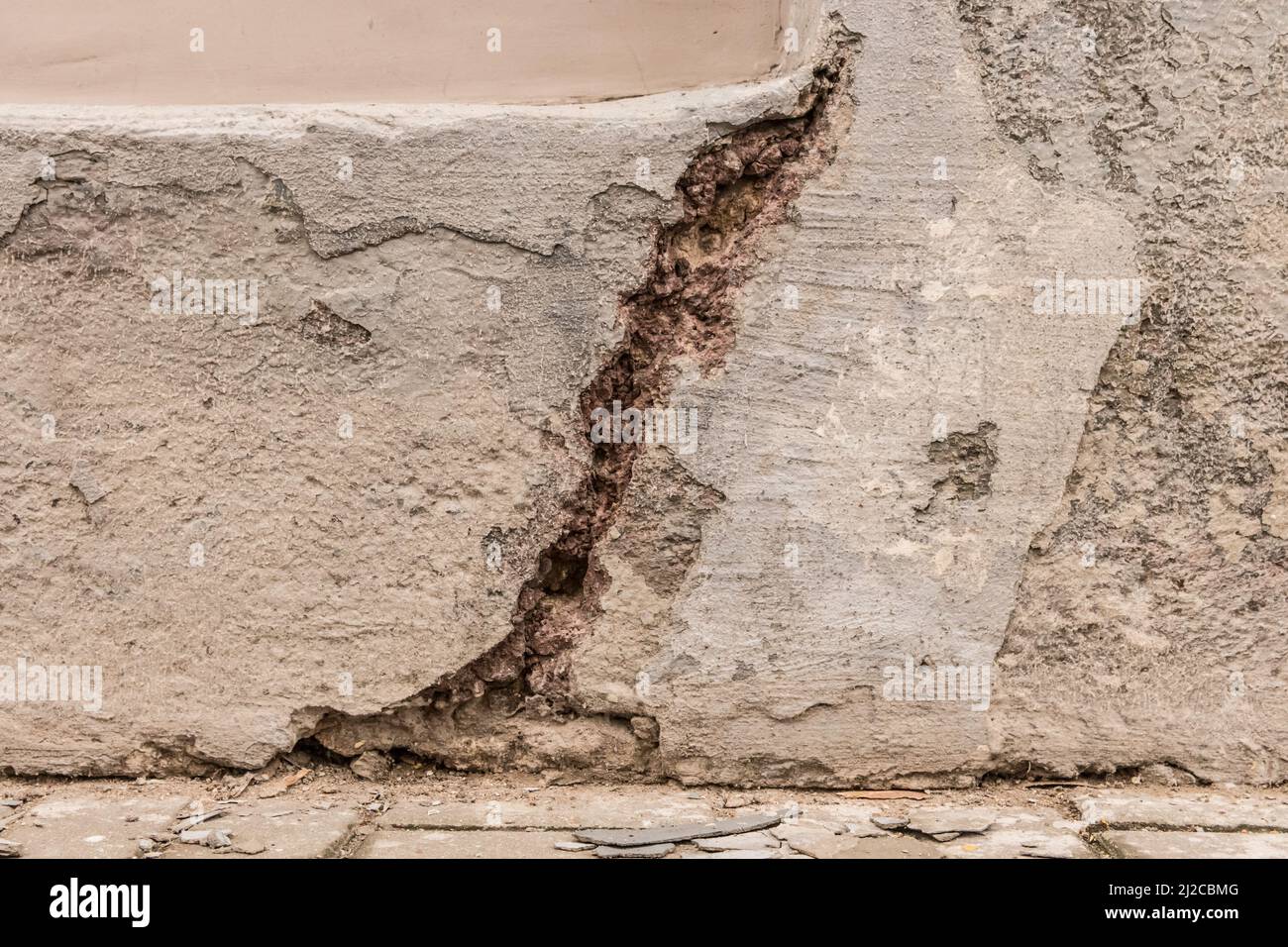A crack in the old concrete is a close-up. Broken cement worn texture ...