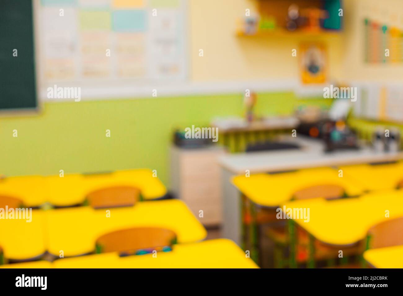 Blurred view of school classroom without young student Stock Photo - Alamy