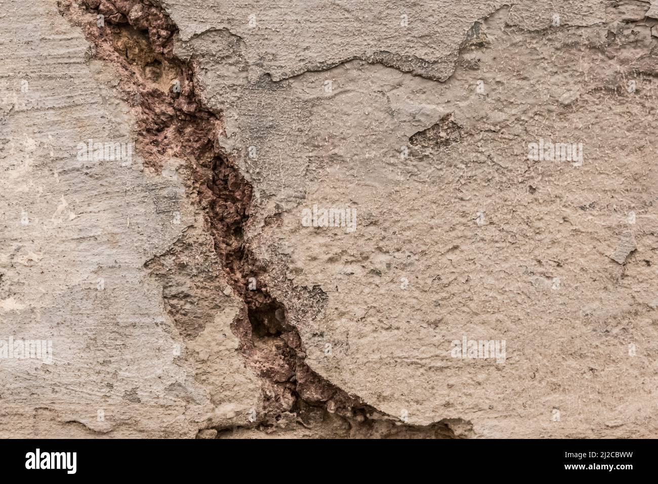 A crack in the old concrete is a close-up. Broken cement worn texture ...