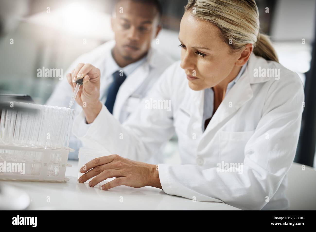 Lets test these samples. Cropped shot of two scientists testing a ...