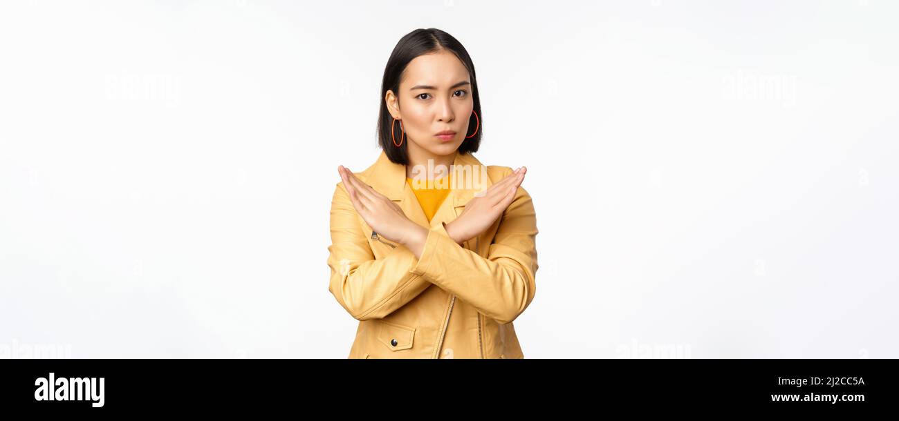 Stop gesture. Serious asian woman making arm cross, prohibit smth ...