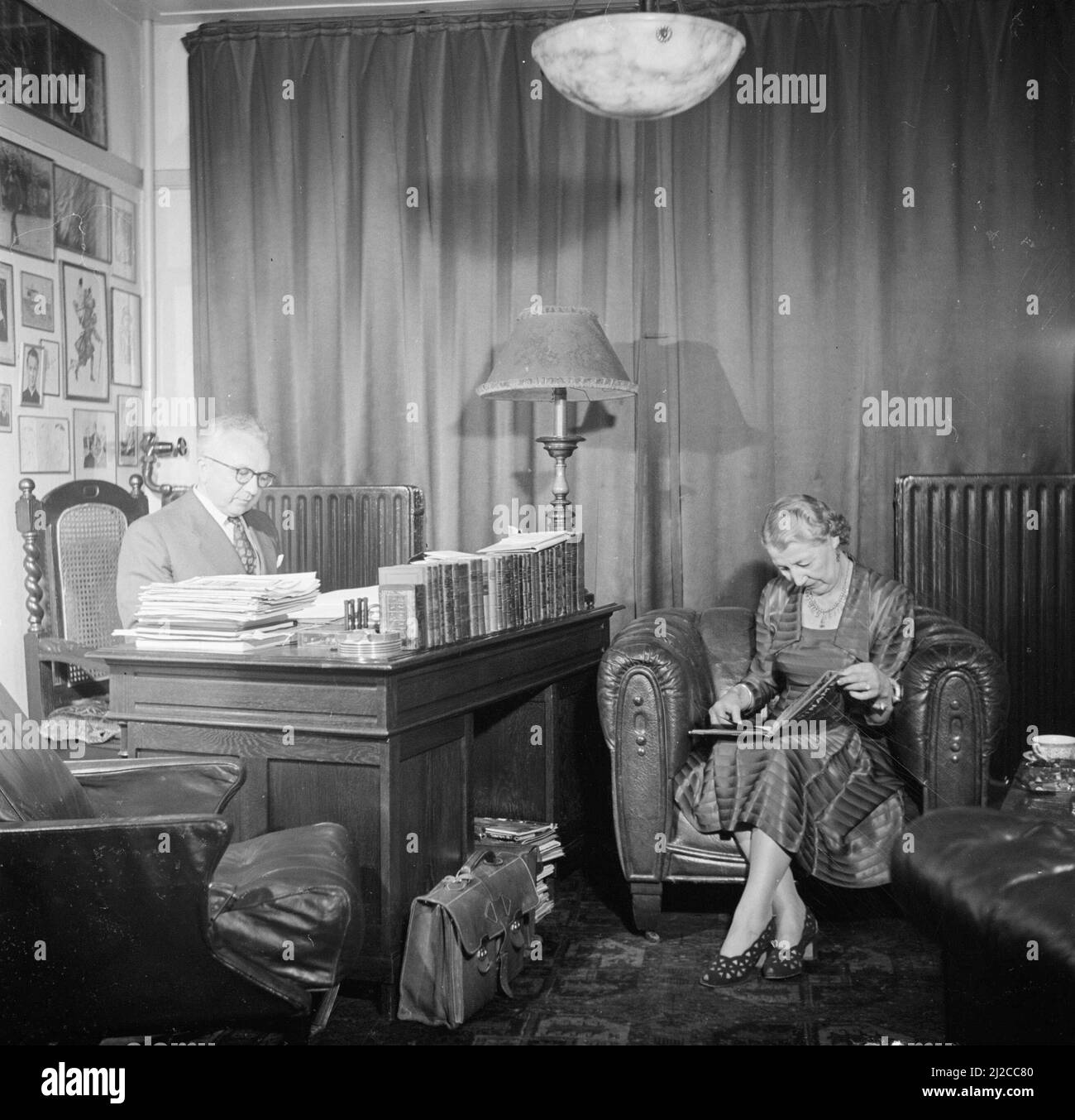 Mr Dellaert at his desk at home. With his wife in an armchair ca: May ...
