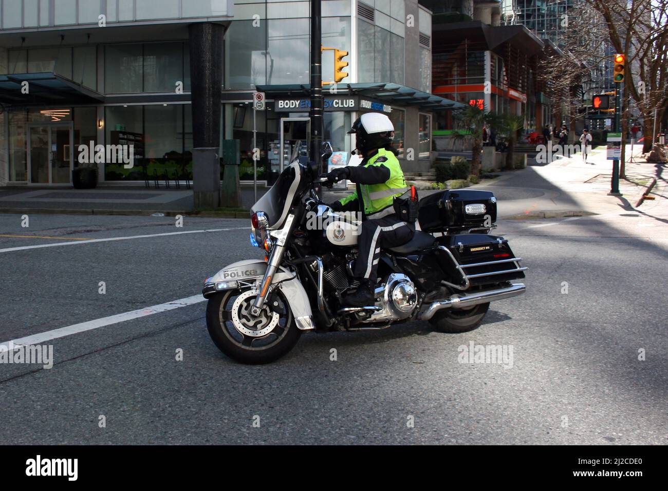 A Police officer riding a motorcycle in downtown Vancouver, british ...