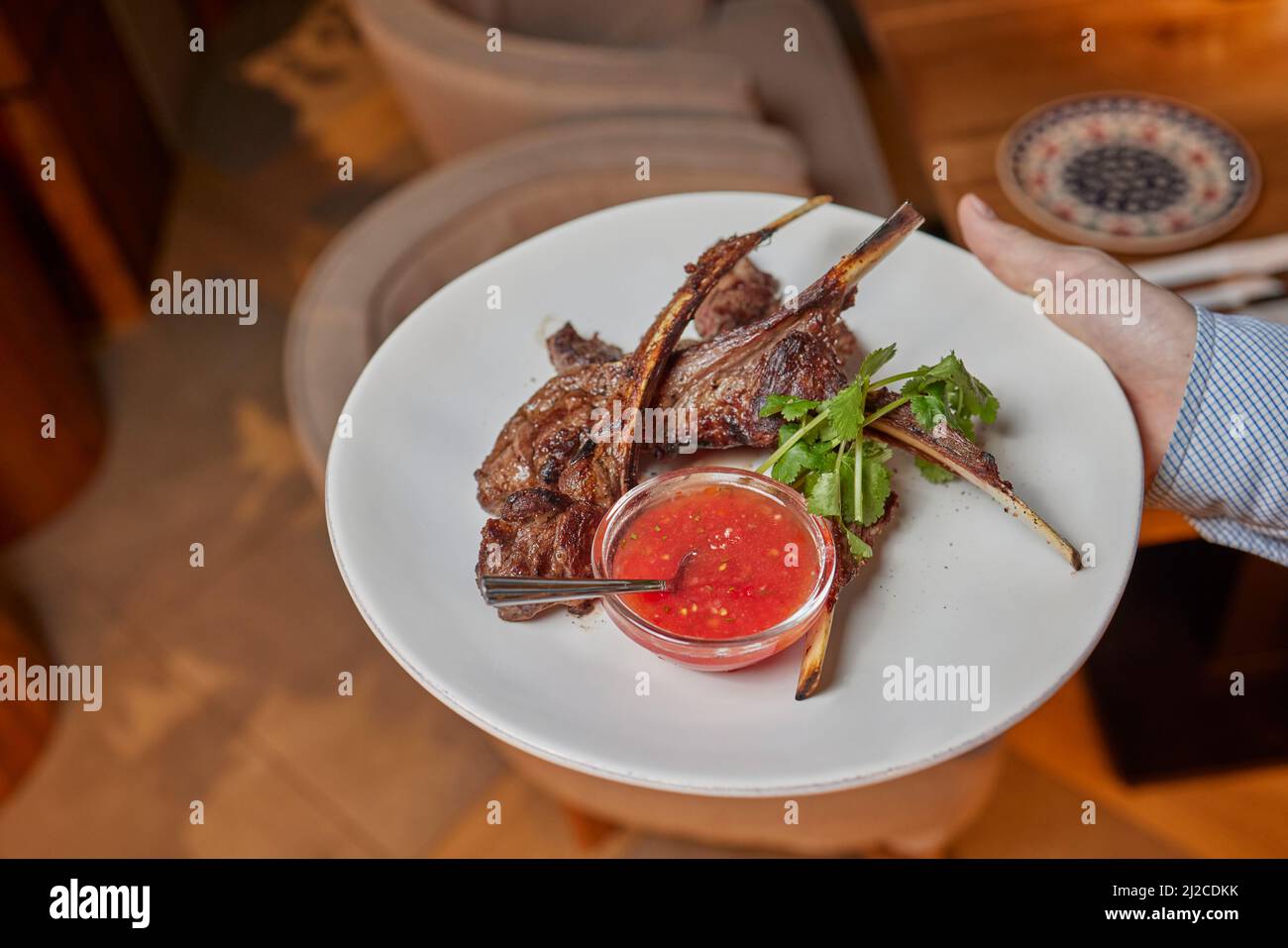 Grilled rack of lamb, close-up. Lamb bone medallions from the chef ...