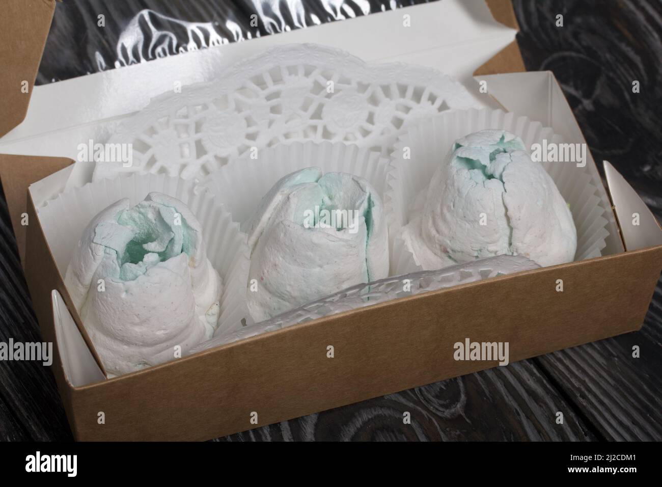 Tulips from marshmallows. Zephyr flowers. In craft packaging. Close-up ...