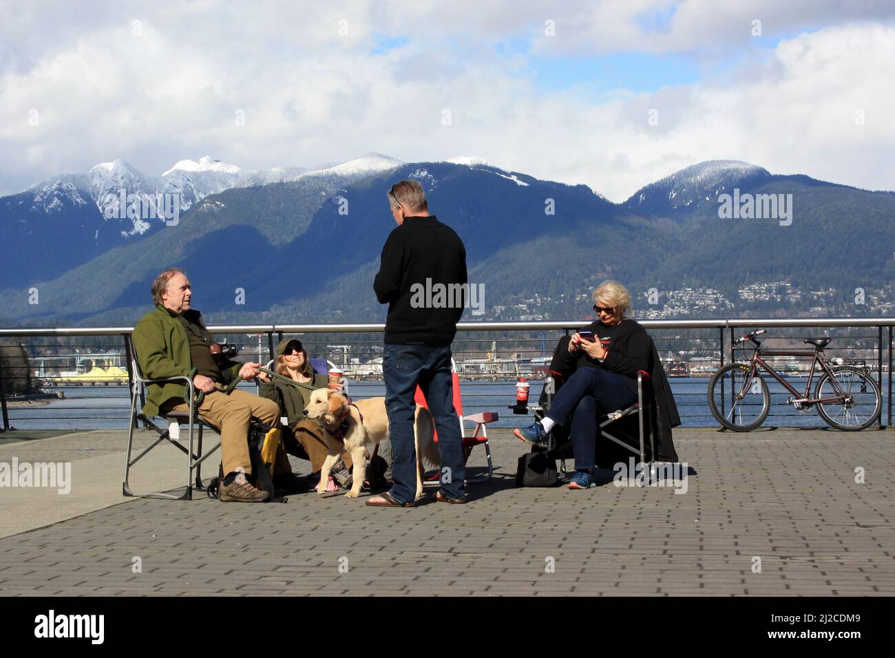 The People are sitting in the sun in downtown Vancouver, British ...