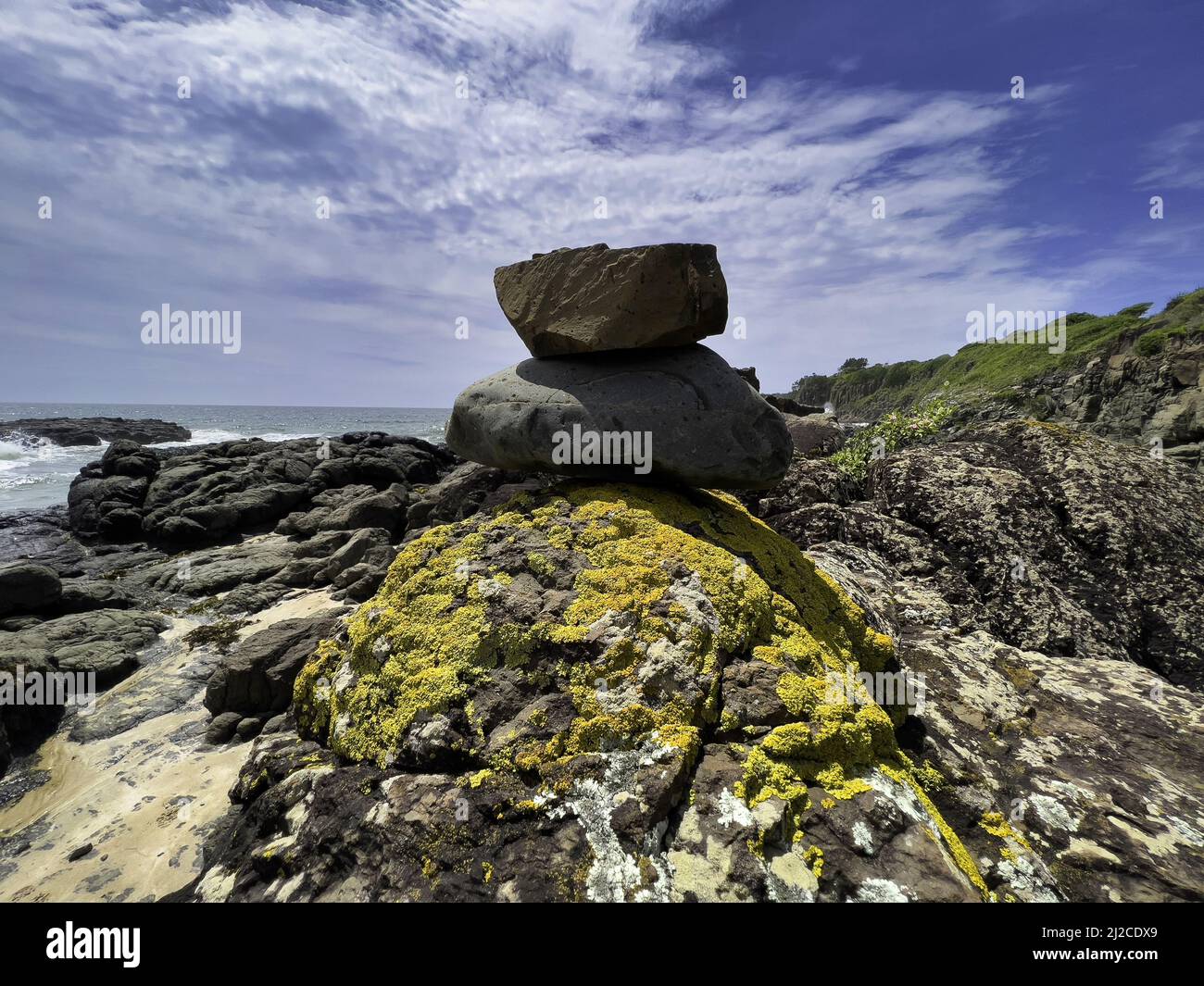 Calming stacked rocks on a big rock with yellow algae at Cathedral ...