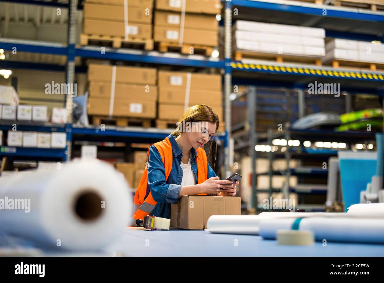 Female production worker smartphone hi-res stock photography and images ...