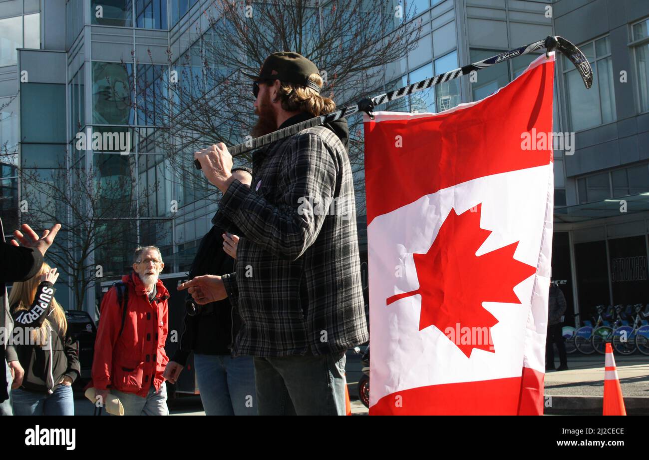 A crowd protesting with Canadian flags and slogans in downtown ...