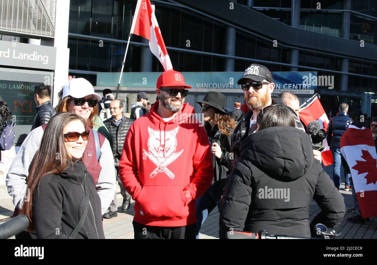 A crowd protesting with Canadian flags and slogans in downtown ...