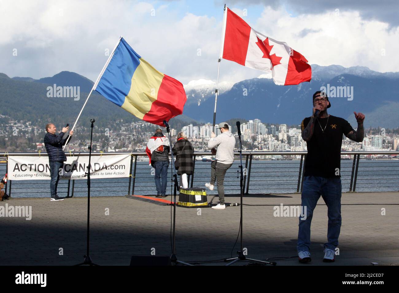 A crowd protesting with Canadian flags and slogans in downtown ...