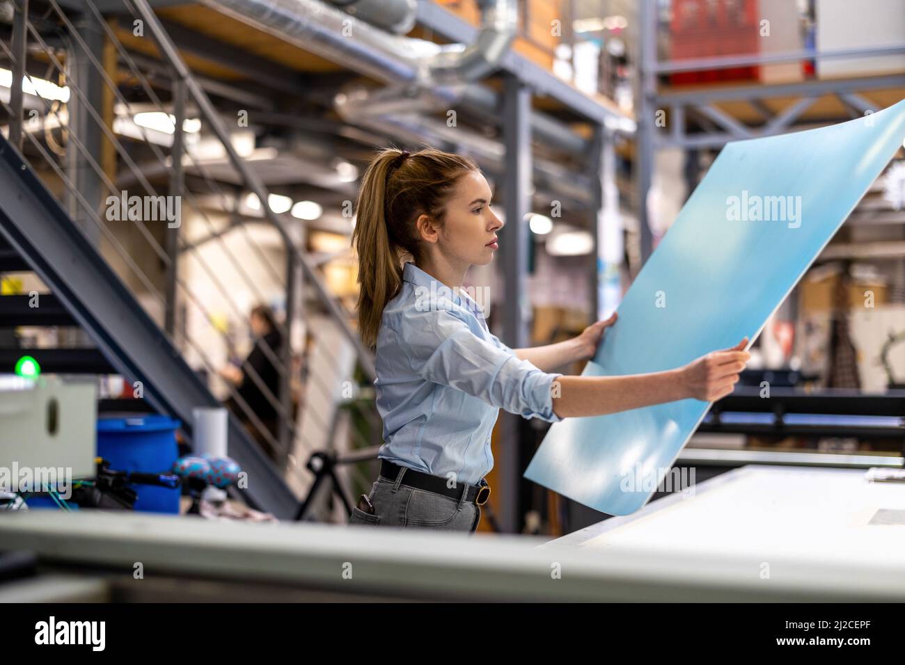 Woman working in printing factory Stock Photo - Alamy
