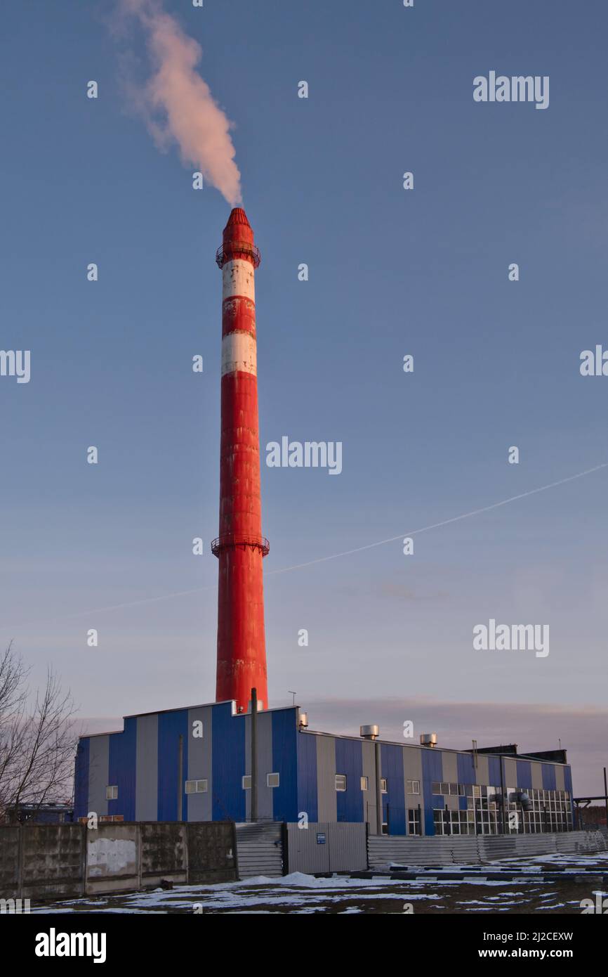 District boiler house with tall red concrete chimney. Object of the ...