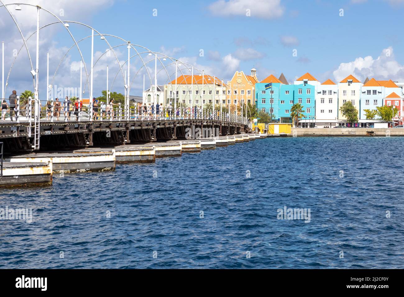 The famous Queen-Emma-Bridge with colorful buildings of the district ...