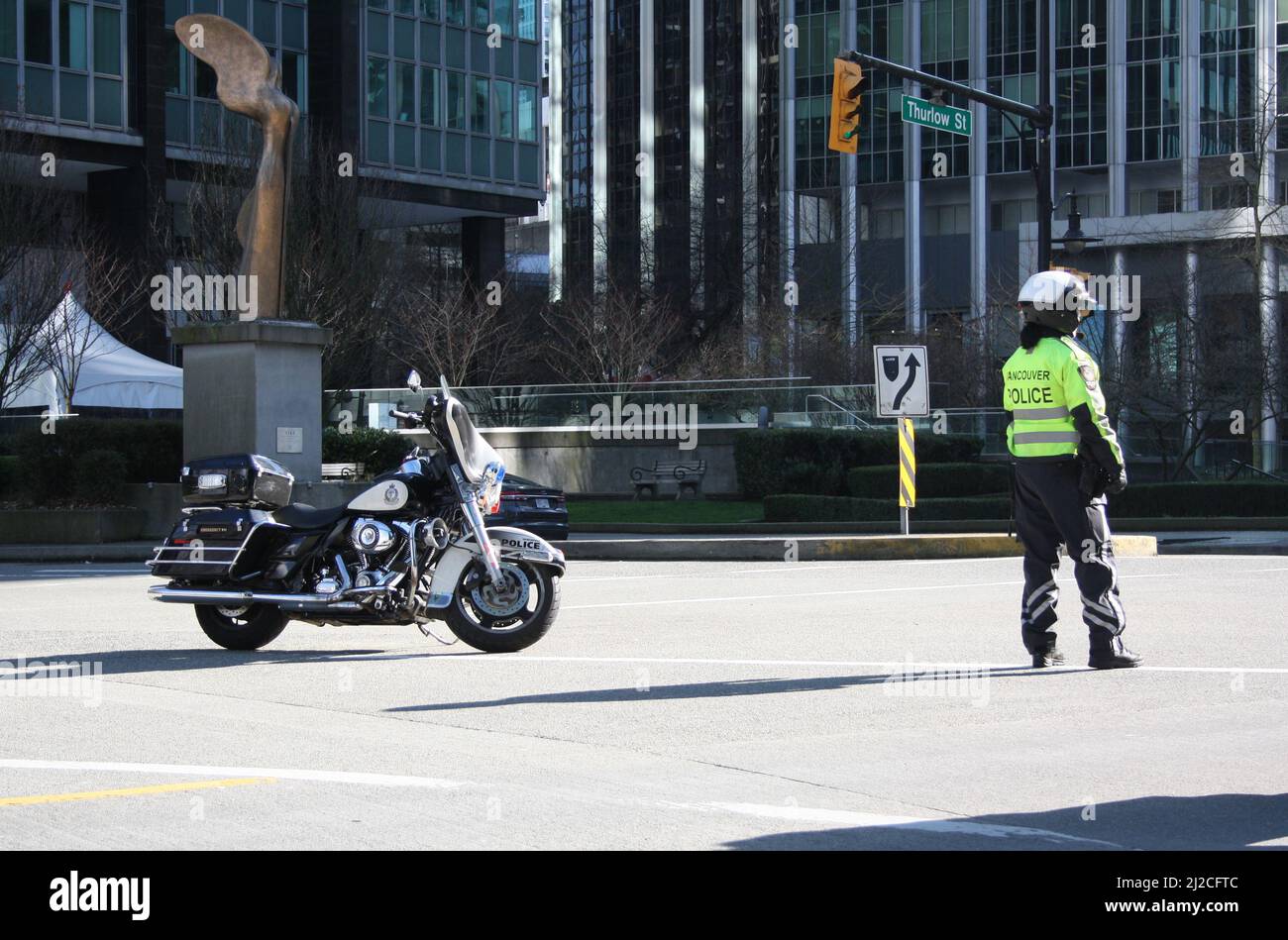A police officer with his motorcycle in the street of Vancouver ...