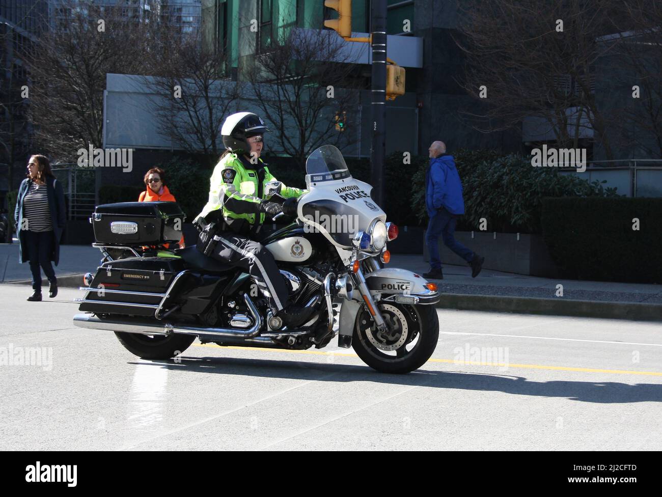 The police officer riding a classic motorcycle in downtown Vancouver ...