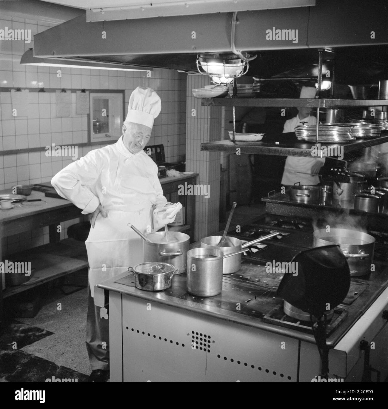 1950s chef cooking food in a large kitchen ca: June 26, 1954 Stock ...