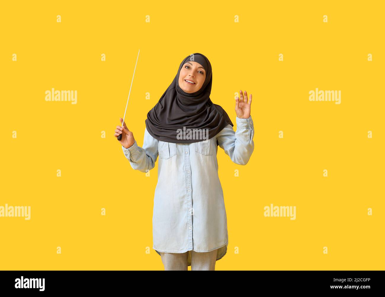Muslim music teacher on color background Stock Photo - Alamy