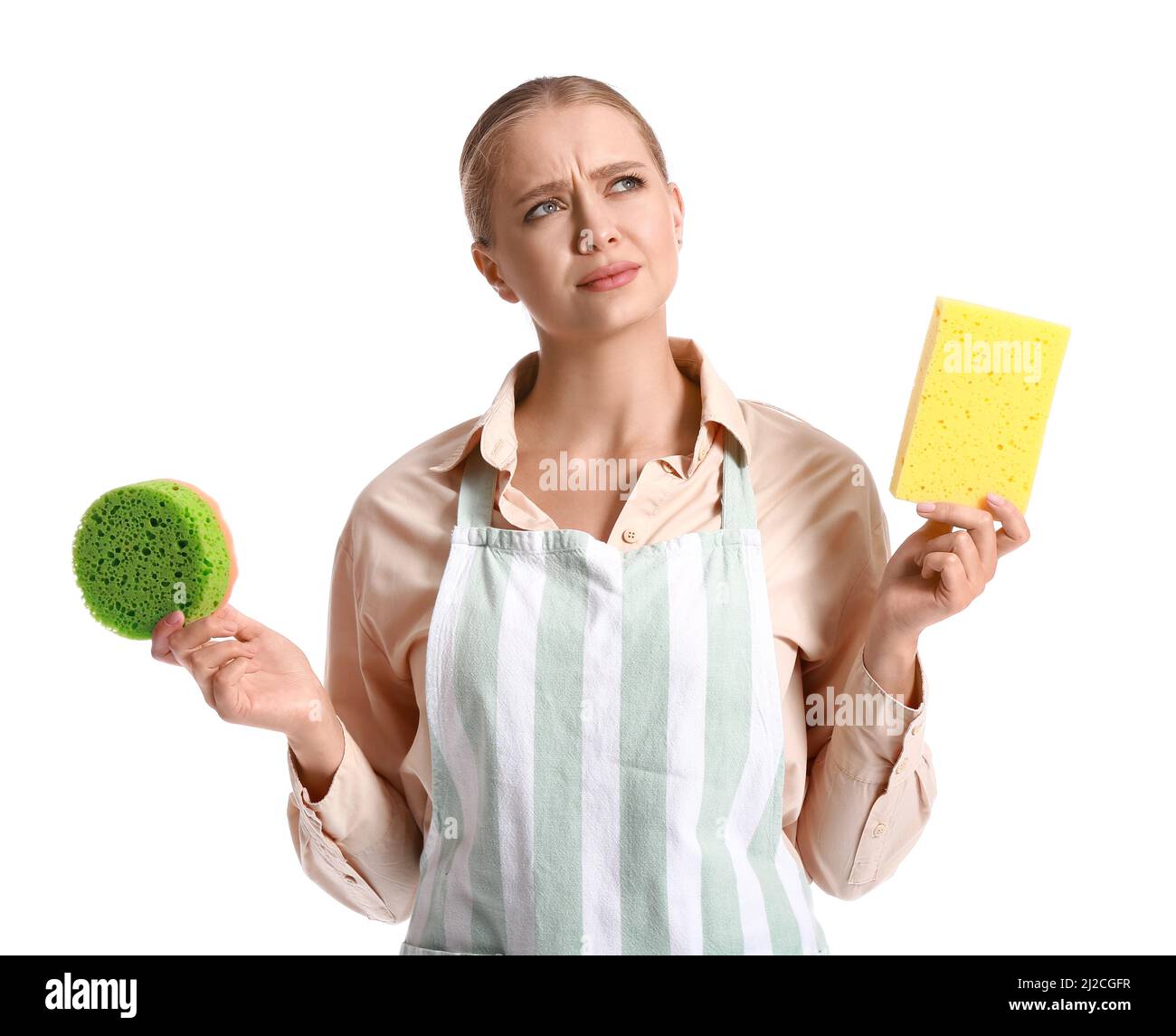 Thoughtful young woman with sponges on white background Stock Photo - Alamy