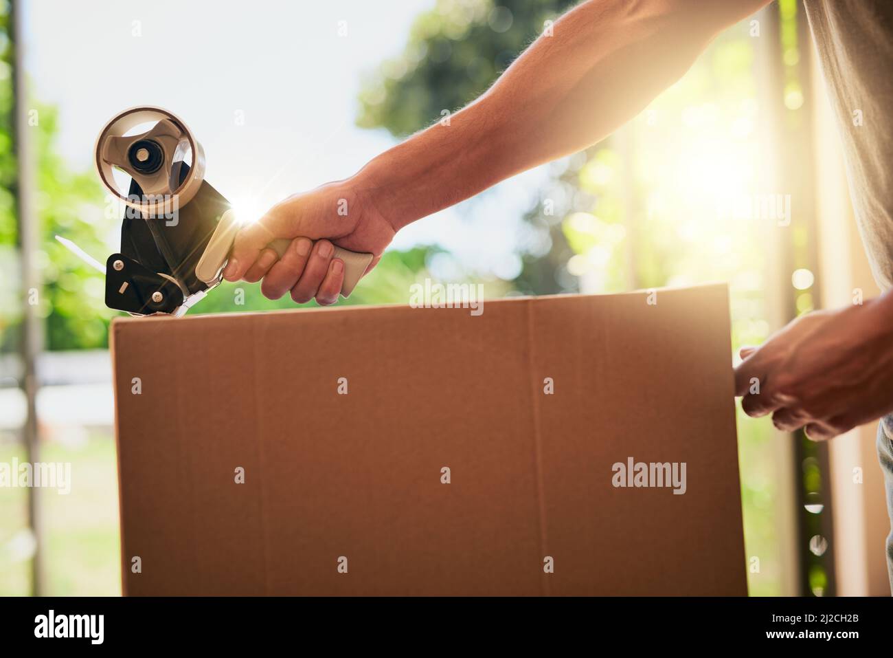 The very last box.... Closeup shot of an unrecognizable man closing a ...