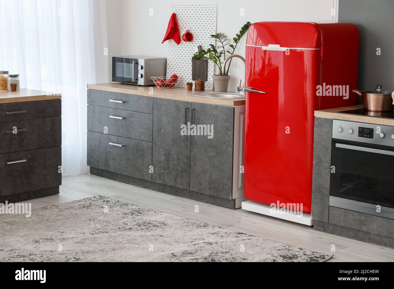 Red retro fridge and modern counters in kitchen Stock Photo - Alamy