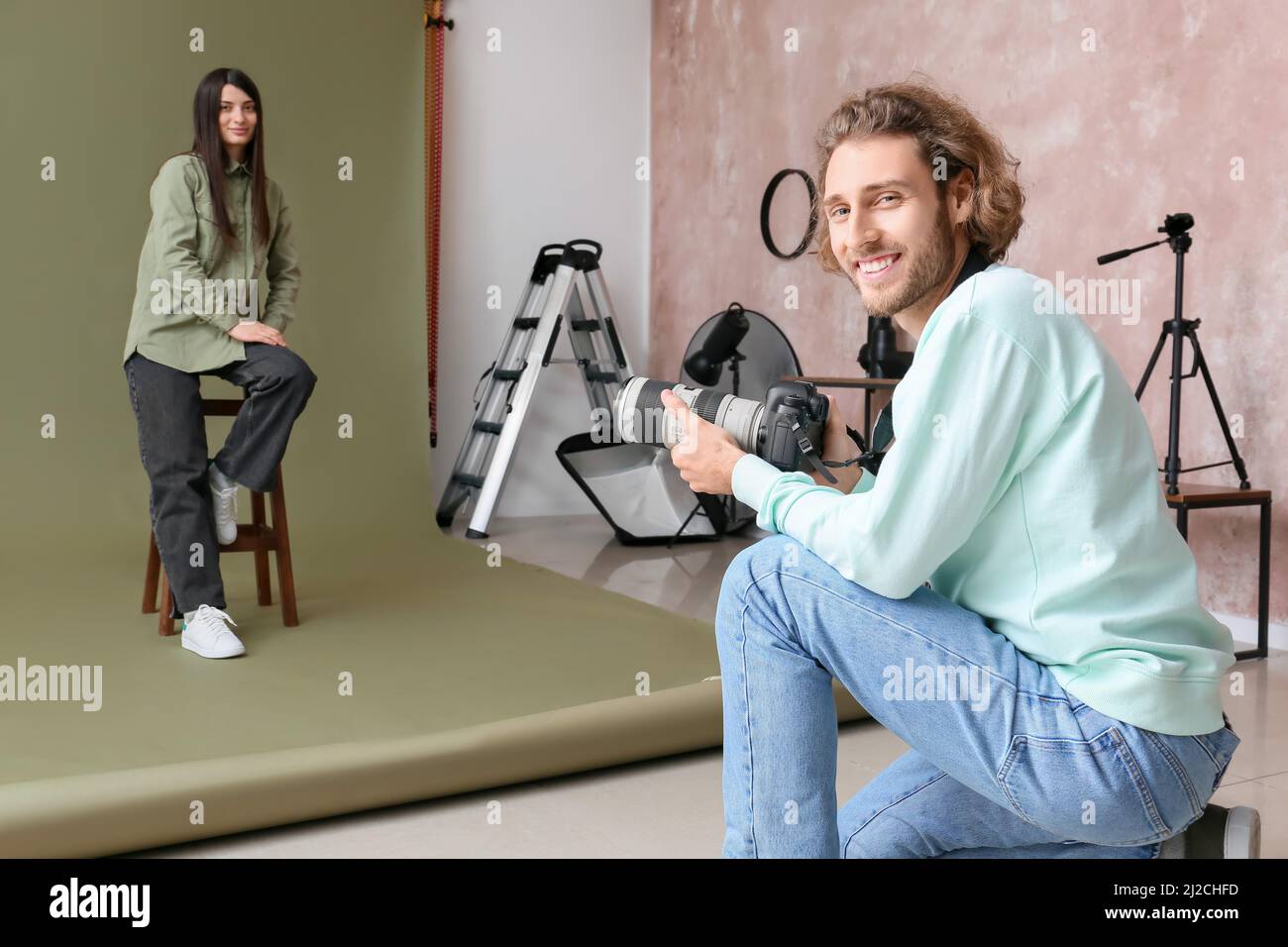 Photographer working with female model in studio Stock Photo - Alamy
