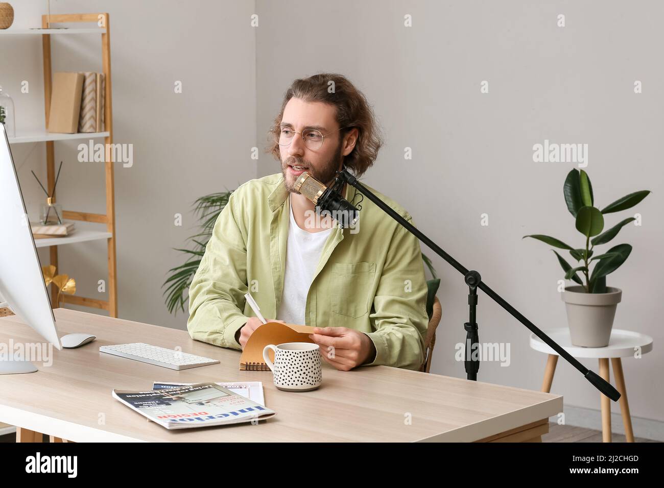 Streamer recording podcast using microphone hi-res stock photography ...