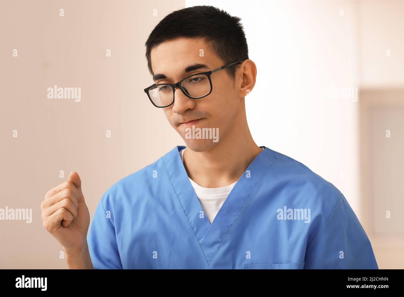 Male Asian doctor worrying in clinic Stock Photo - Alamy