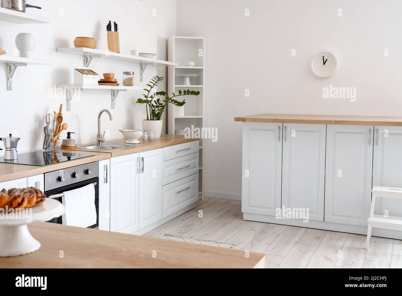 Counters with different utensils near white wall in kitchen interior ...