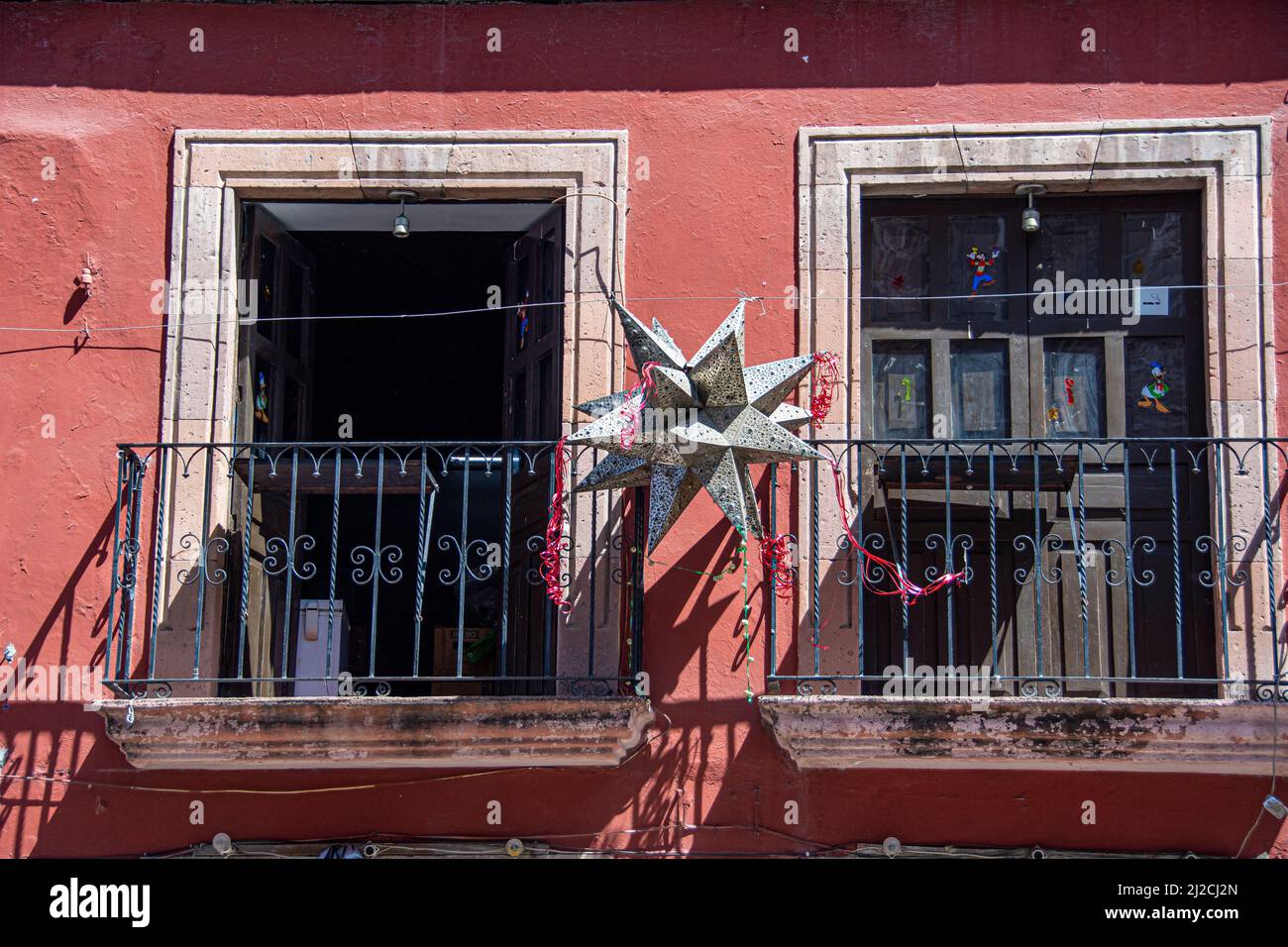 A large, tin star decorates a pair of wrought-iron balconies. San ...