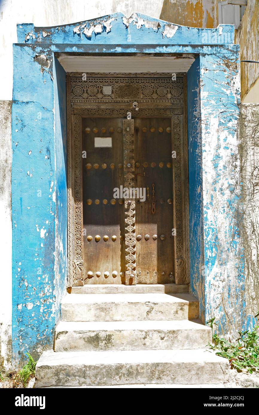 Old doors in Zanzibar, Tanzania. Weathered blue paint on the wall Stock ...